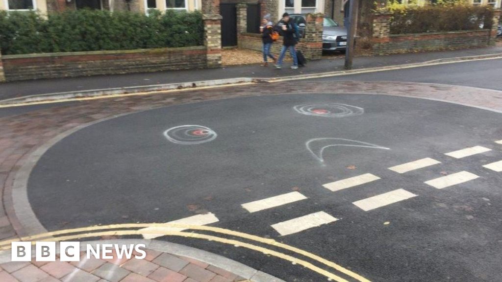 Cambridge 'ghost roundabout' given eyes and mouth - BBC News