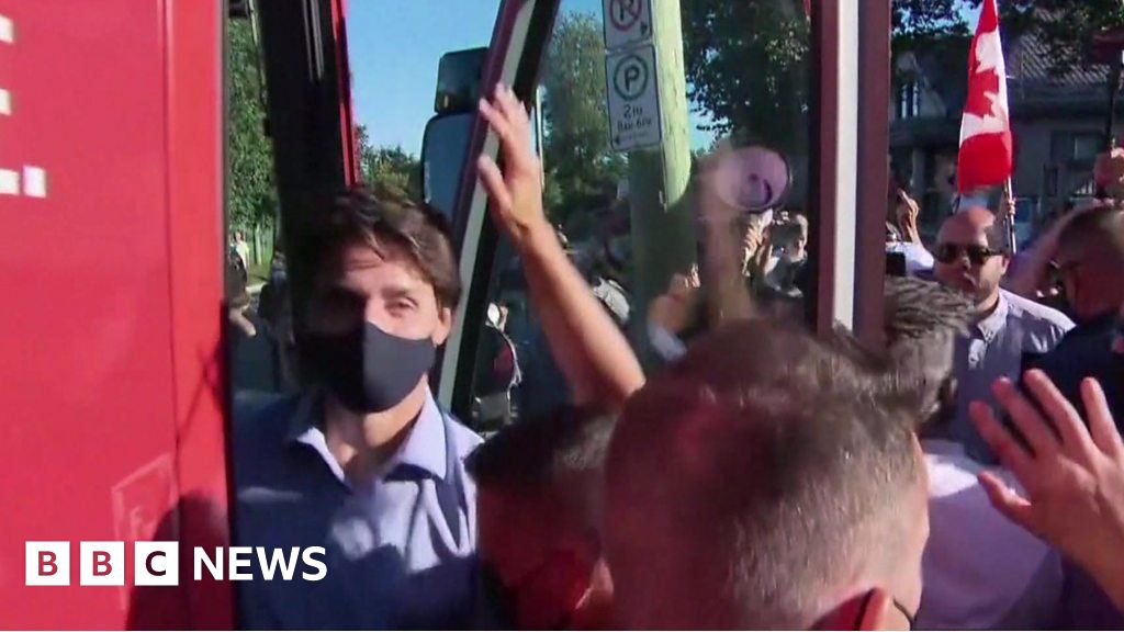Moment Justin Trudeau hit by gravel - BBC News