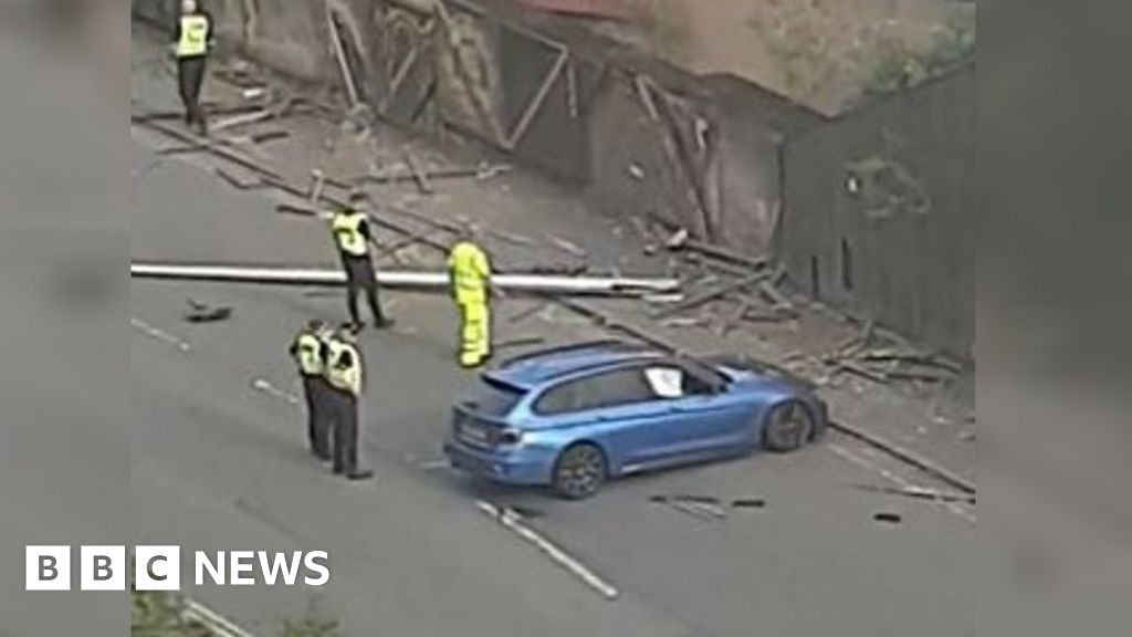 Driver flees after BMW crashes into lamp-posts and wall