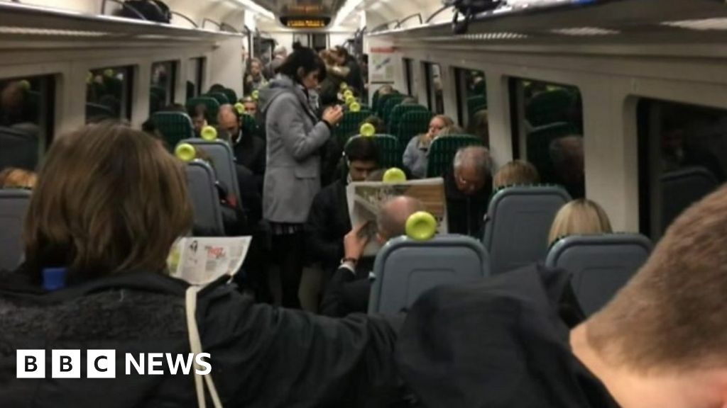Rail passengers 'squashed in like animals going to market' - BBC News
