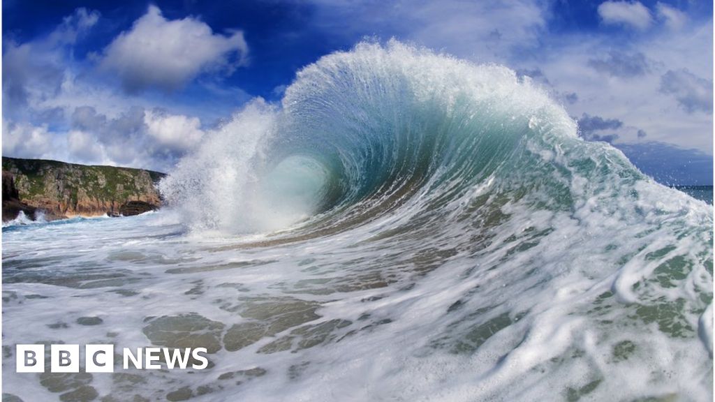 Cornwall photographer captures beauty inside raging waves - BBC News