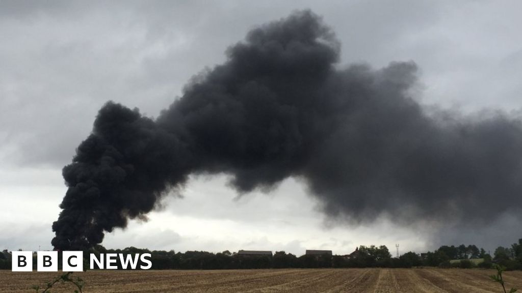Homes evacuated after fire leads to explosions - BBC News
