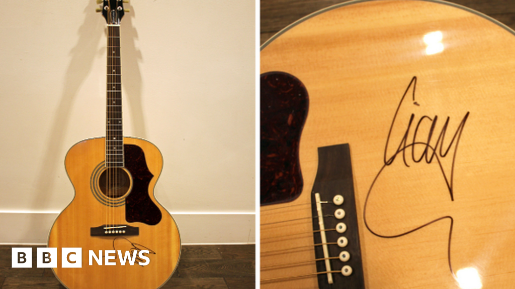 Liam Gallagher guitar stolen from blind woman in Birmingham - BBC News