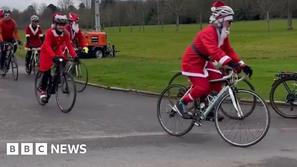 Dozens of cyclists dress as Santa for a Christmas ride