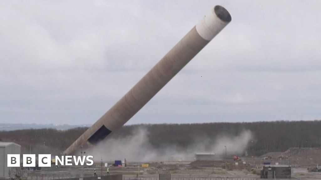Holyhead: Watch moment 450ft chimney is demolished - BBC News