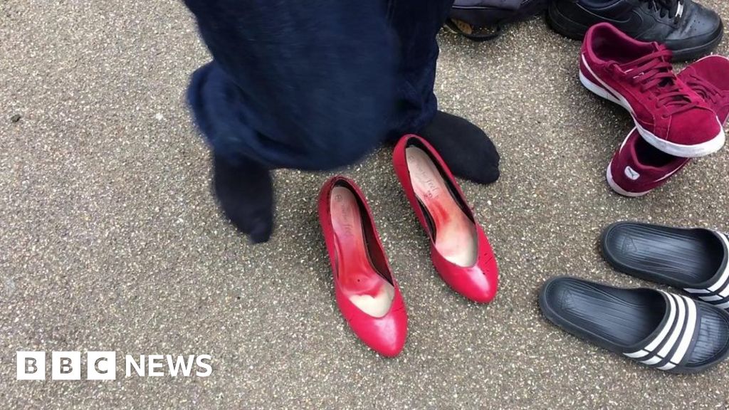 Cardiff men walk 'a mile in her shoes' over domestic abuse - BBC News