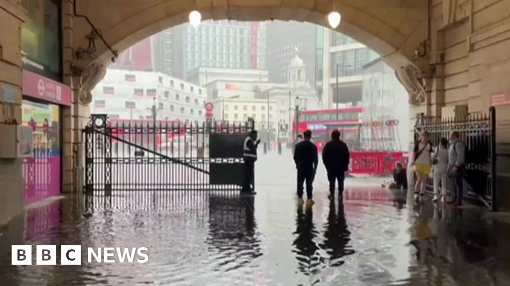UK weather: Heavy rain floods London Tube stations and roads - BBC News