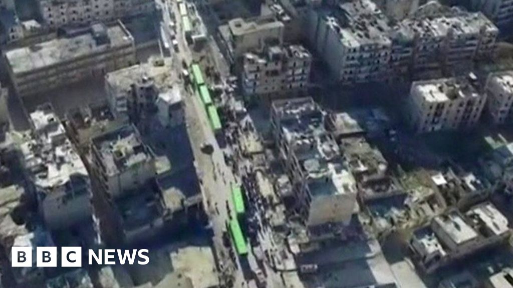 Aleppo Syria battle: Aerial footage shows evacuation - BBC News