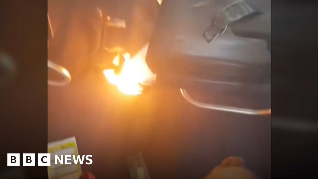 Mobile catches fire on a Barcelona-Ibiza Ryanair plane - BBC News