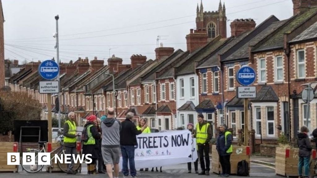 'Human bollards' block vehicles from Exeter buses-only road - BBC News