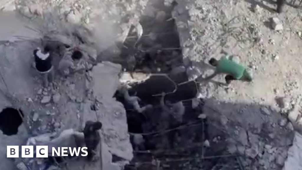 People sift through rubble at Al-Nuseirat refugee camp in Gaza - BBC News