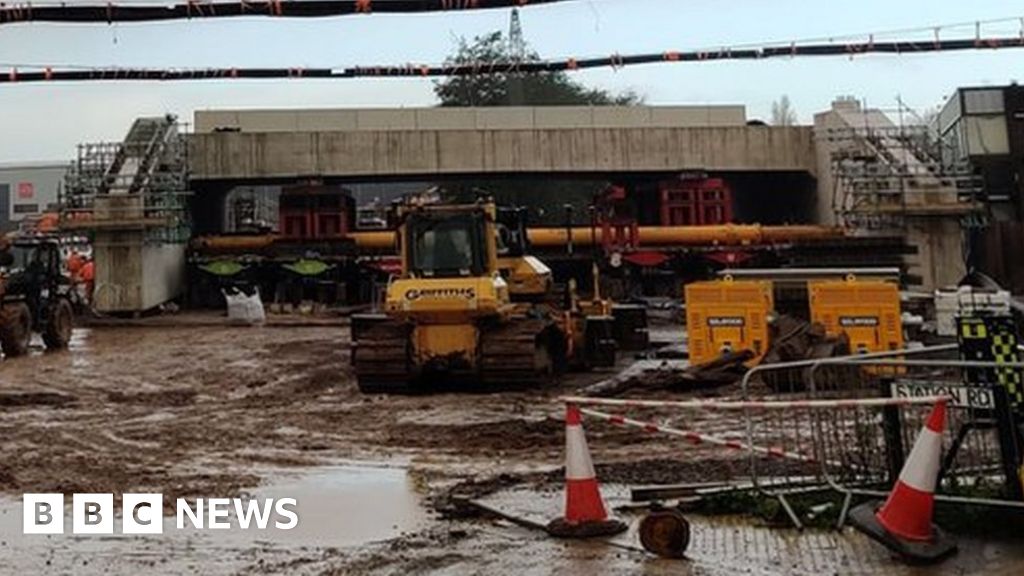 Lorries moving new railway bridge stuck in mud - BBC News