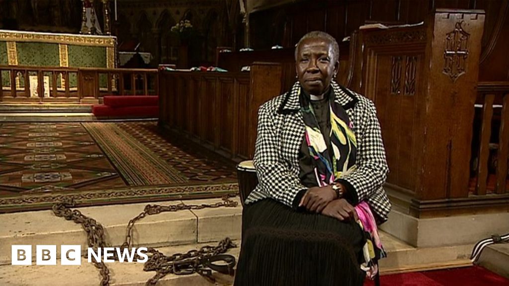 Black priest walks in 'slave' chains to promote remembrance - BBC News