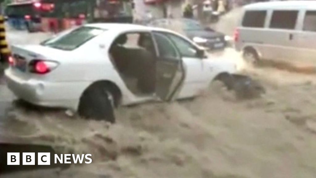 Cars swept down streets in Chinese city - BBC News