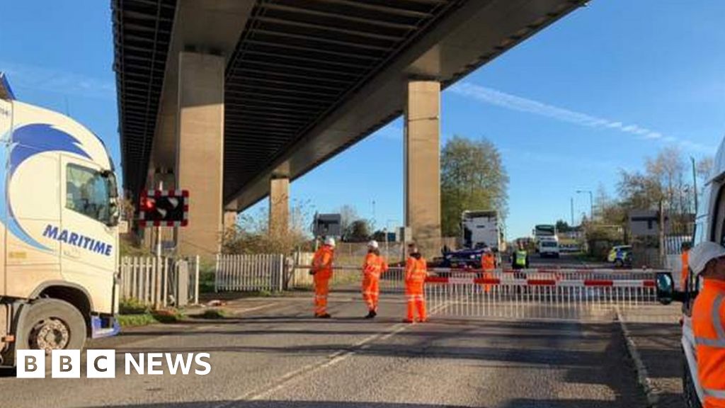 Barrier ripped off as lorry hits level crossing - BBC News