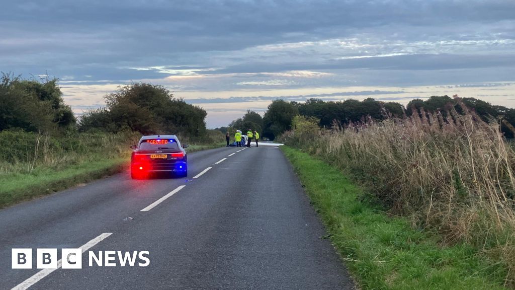 Light aircraft crashes onto road sparking major disruption - BBC News