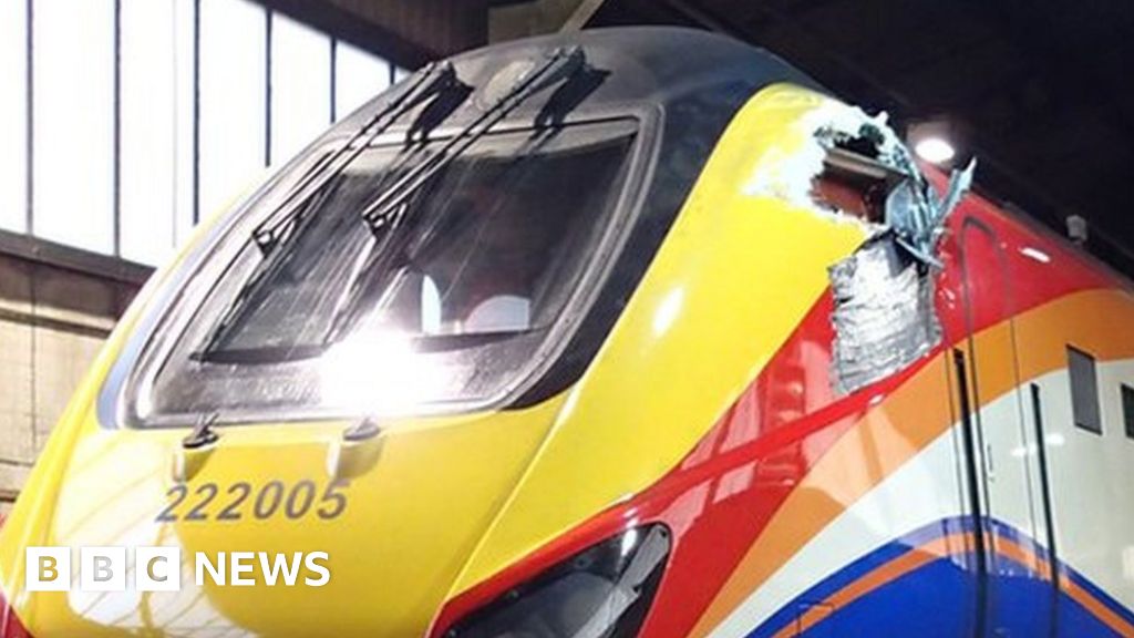 Man hurt when train hit conveyor over line - BBC News