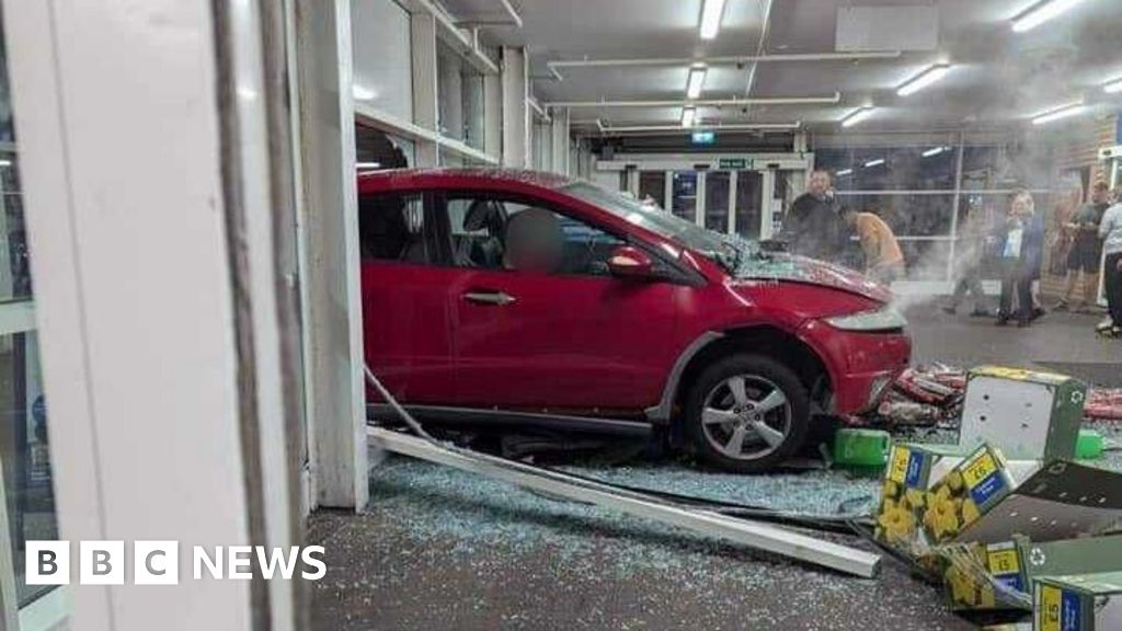Man charged after crashing through front of Greenock Tesco - BBC News