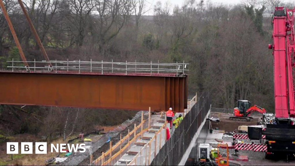 Beams lifted into place over North Calder Water - BBC News