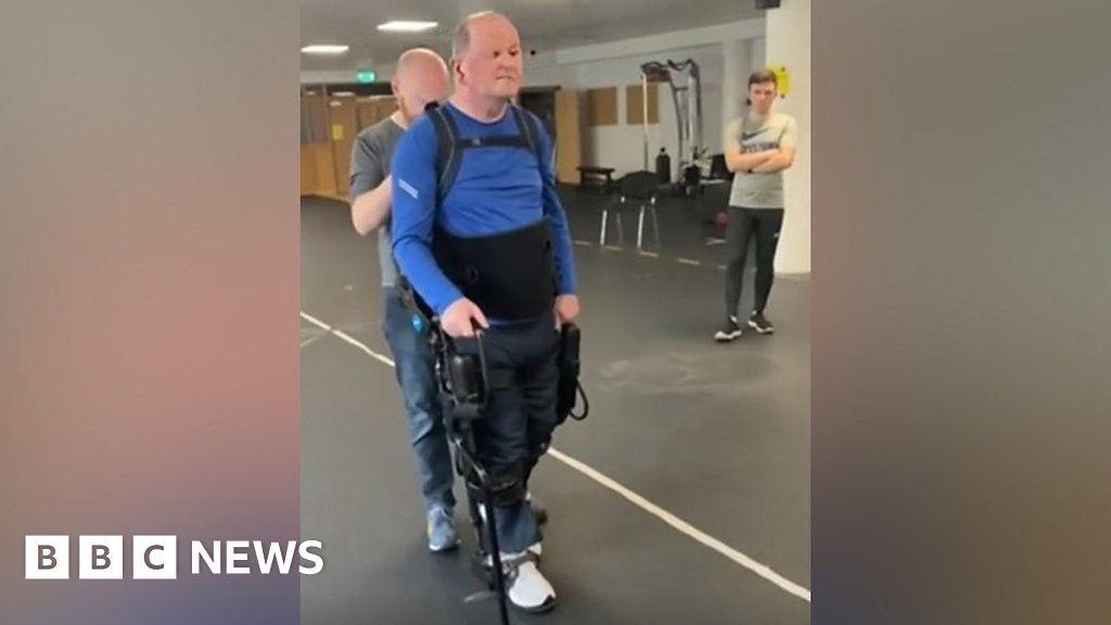Injured football fan walks again with exoskeleton - BBC News