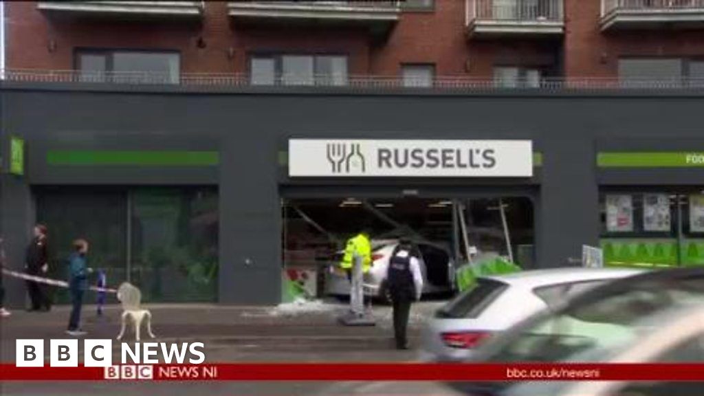 Car crashes into shop window in Belfast - BBC News
