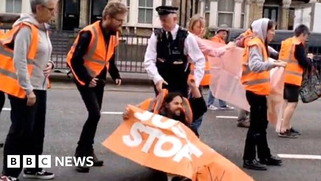 Just Stop Oil protester dragged along road by police officer