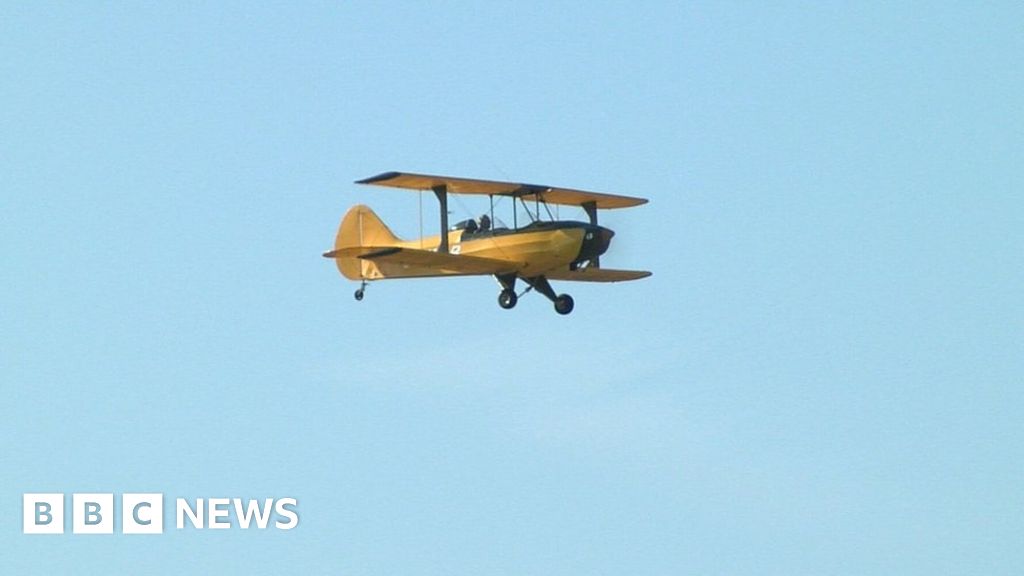 Man completes flight in self-built biplane - BBC News