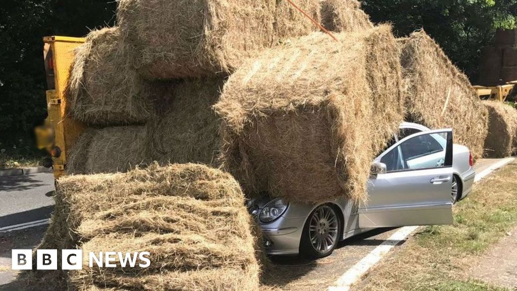 Mercedes Benz car buried under hay bales - BBC News
