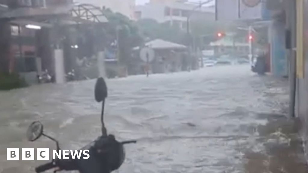 Watch: People rescued as Typhoon floods shops and streets - BBC News
