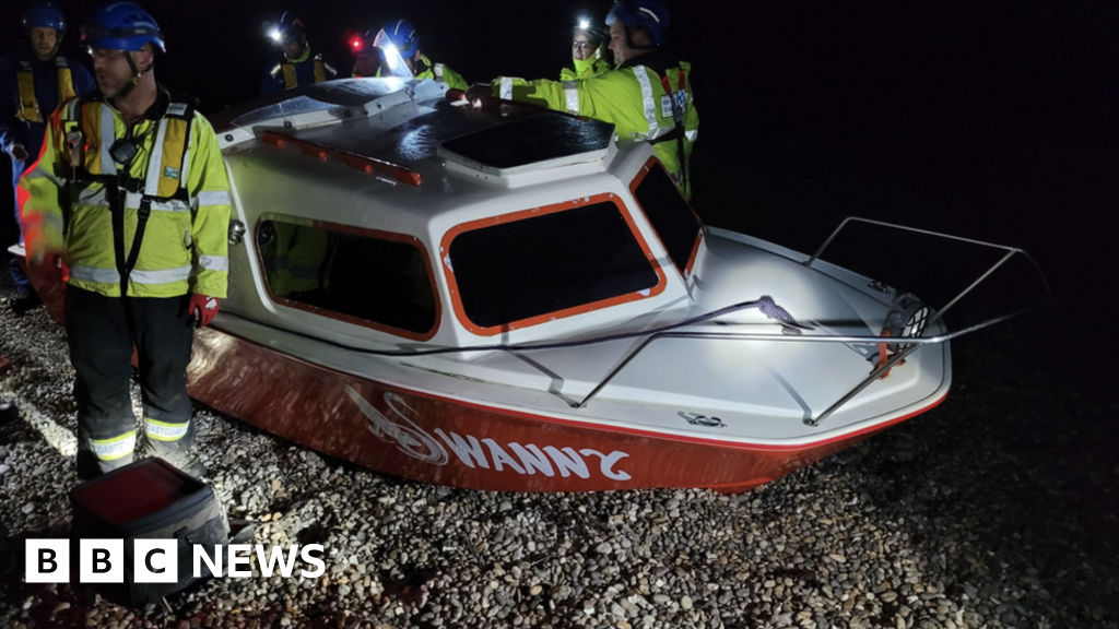 Three men rescued after boat capsizes near Axmouth - BBC News