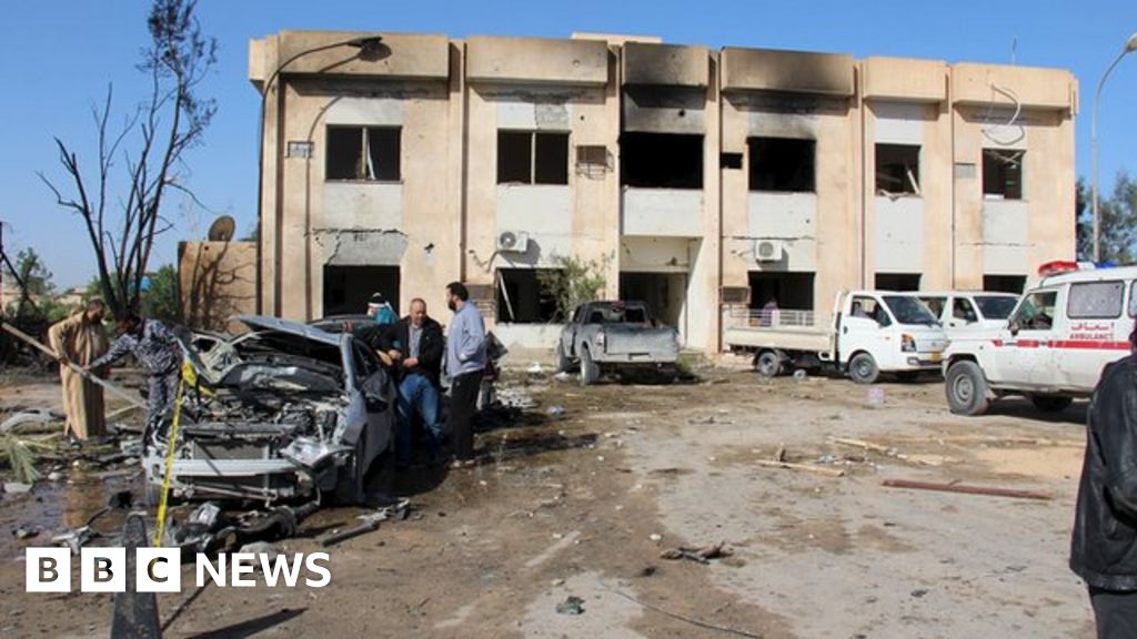 Dozens killed in bomb blast at Libya police base - BBC News