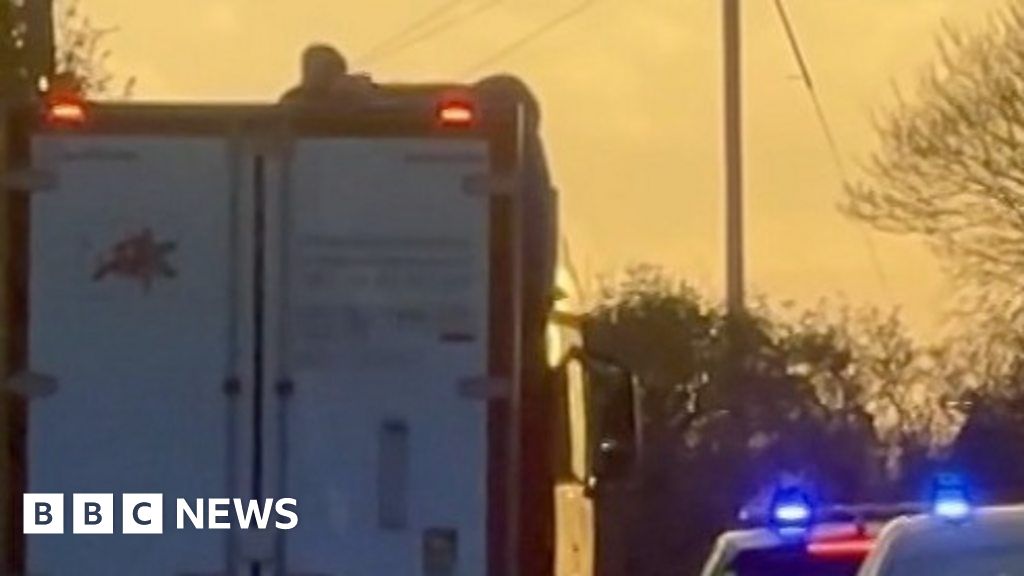 Person seen poking out of roof as police stop lorry - BBC News
