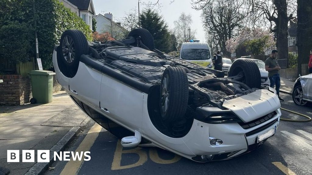 Plumstead driver escapes unhurt as car flips onto roof - BBC News