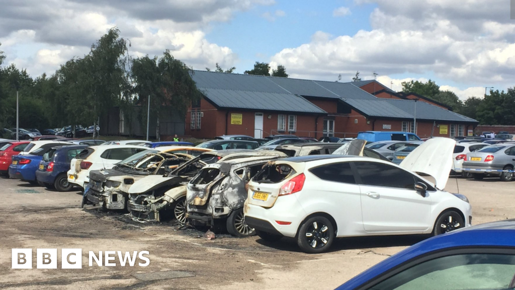 Birmingham prison: 'Armed men' set cars on fire outside jail - BBC News