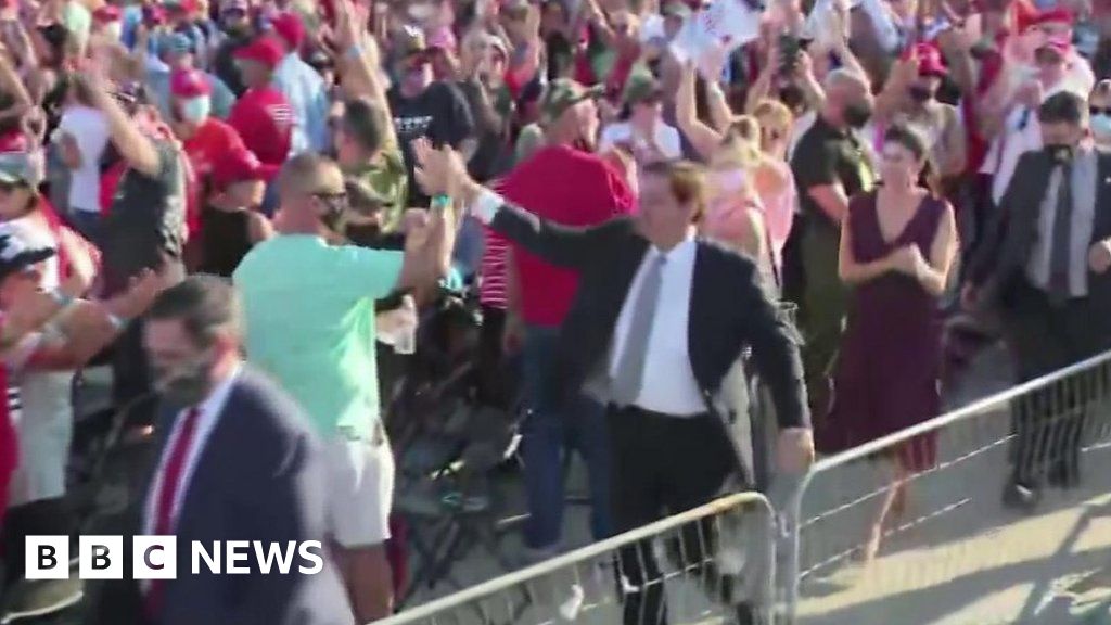 Florida governor Ron DeSantis high-fives supporters at Trump rally