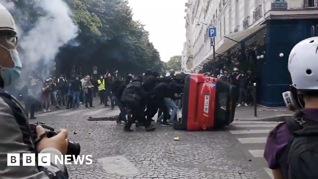 Protesters overturn car to use as barricade in Paris