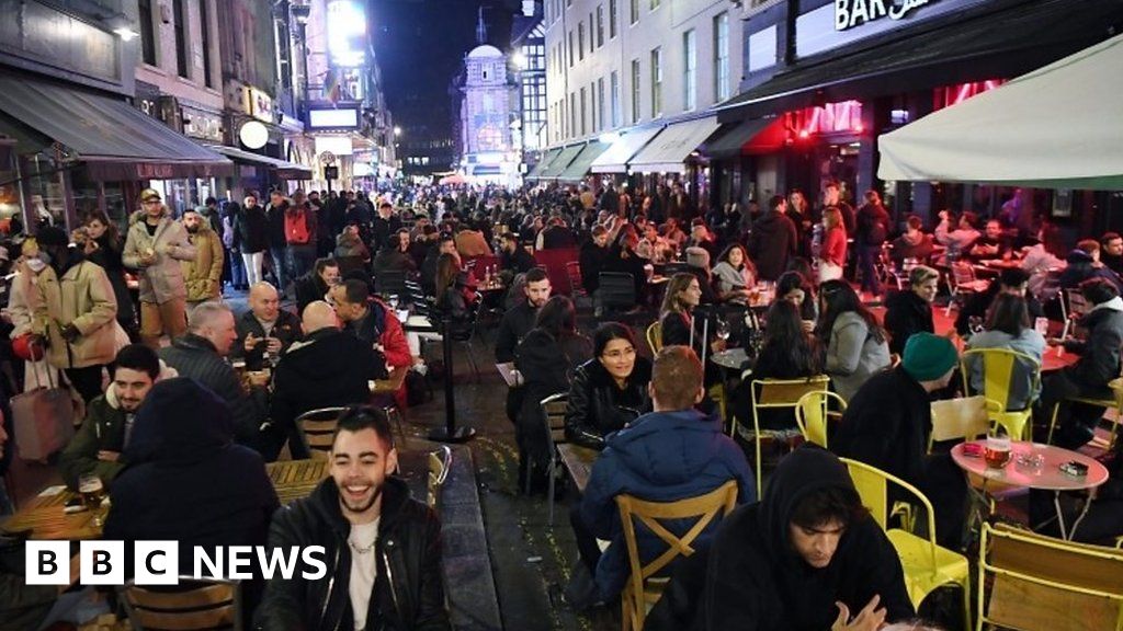 Crowds gather at pubs, clubs and restaurants one night before lock down.