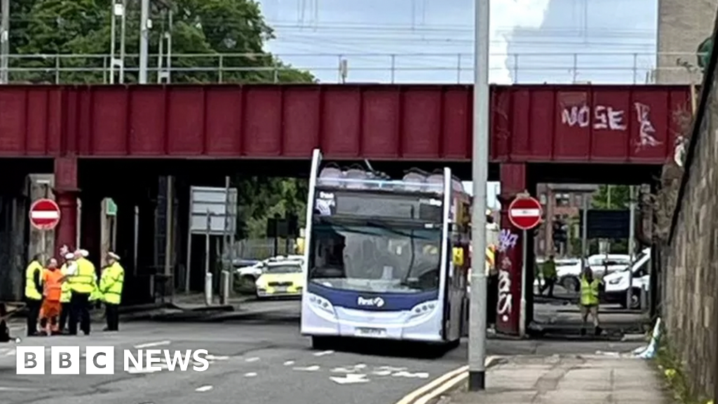 Glasgow crash: Firefighters free bus stuck under bridge