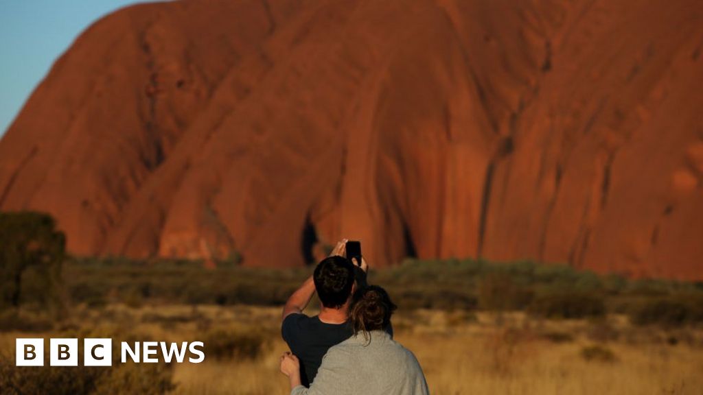 Uluru climbing ban: Tourists to scale sacred rock for final time - BBC News