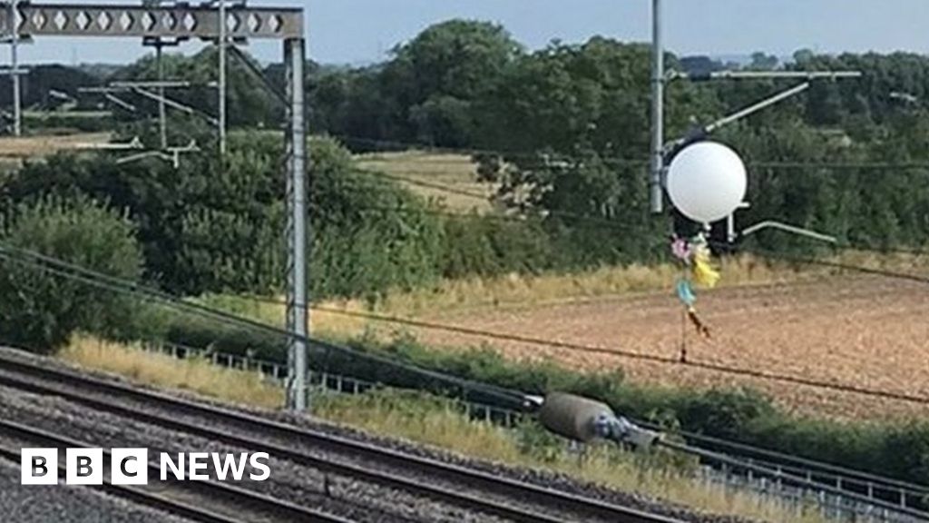 Balloon tangled in wires delays trains near Tamworth - BBC News
