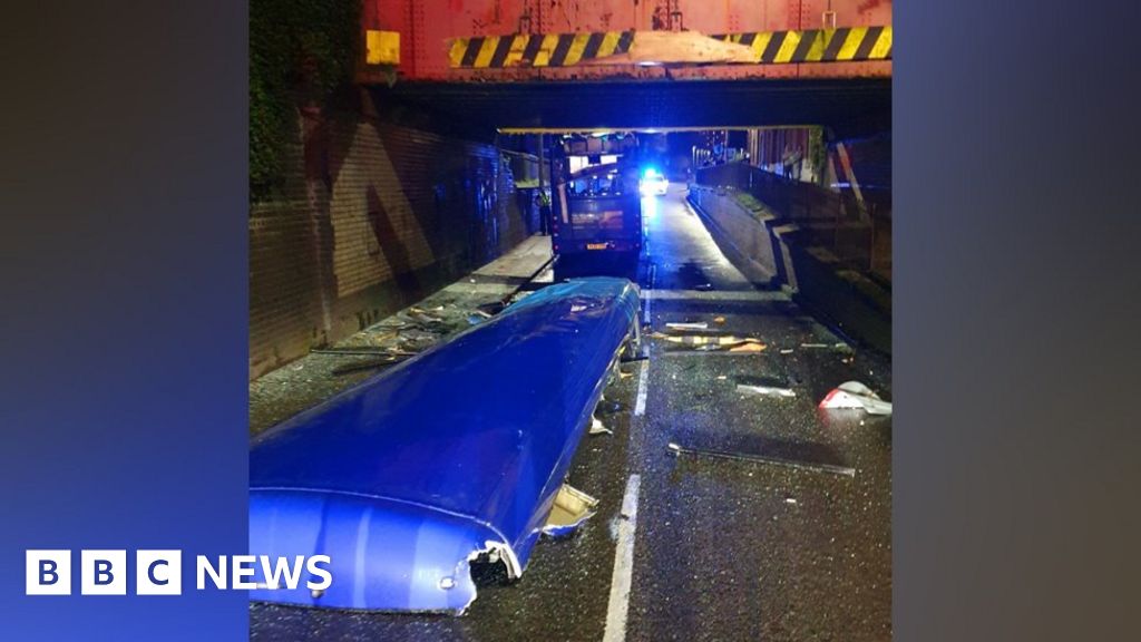 Double decker bus has roof ripped off in Eccles bridge crash - BBC News