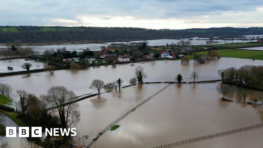 Watch: Drone footage shows hamlet cut off by floods - BBC News
