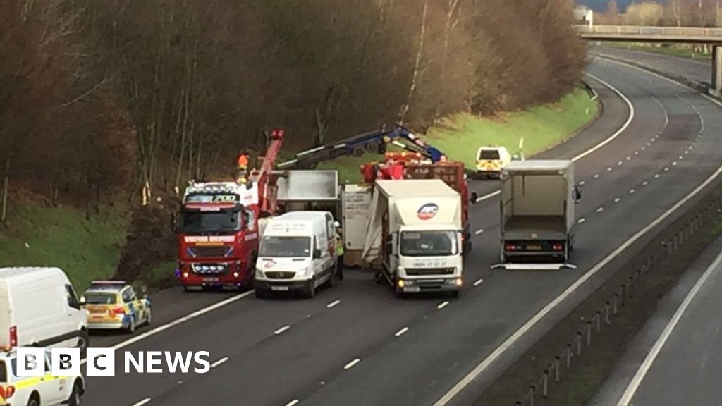 Motorway reopens after lorry overturns - BBC News