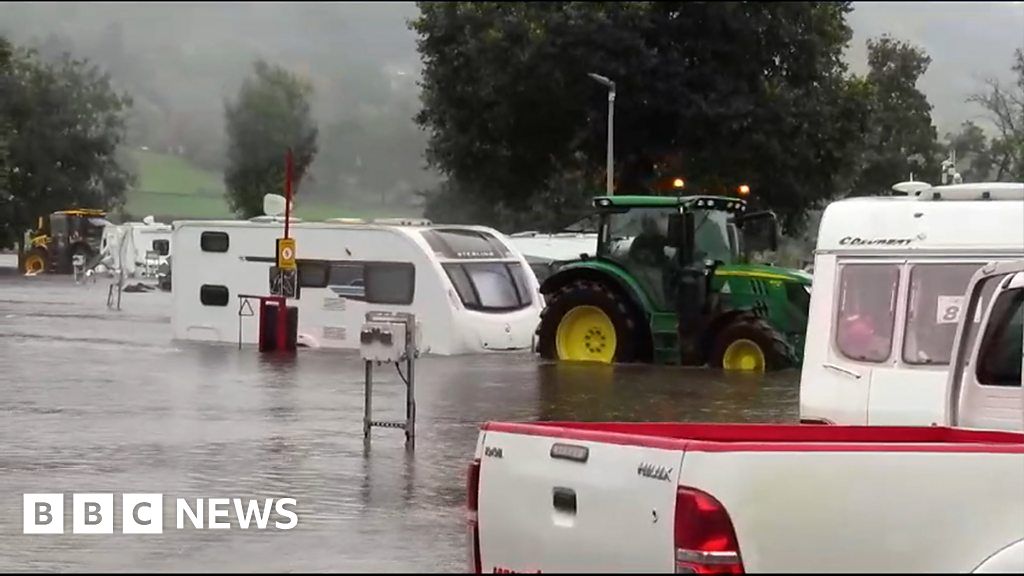 Tractors tow caravans from floodwater in Aberfeldy after heavy rain ...