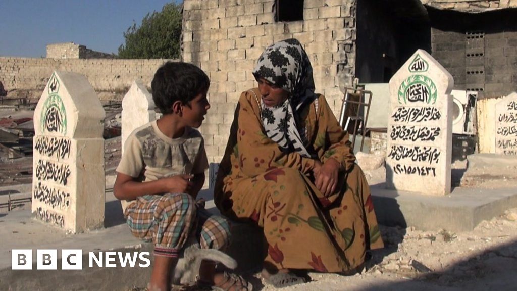 Syrian family living in cemetery in Eastern Aleppo - BBC News