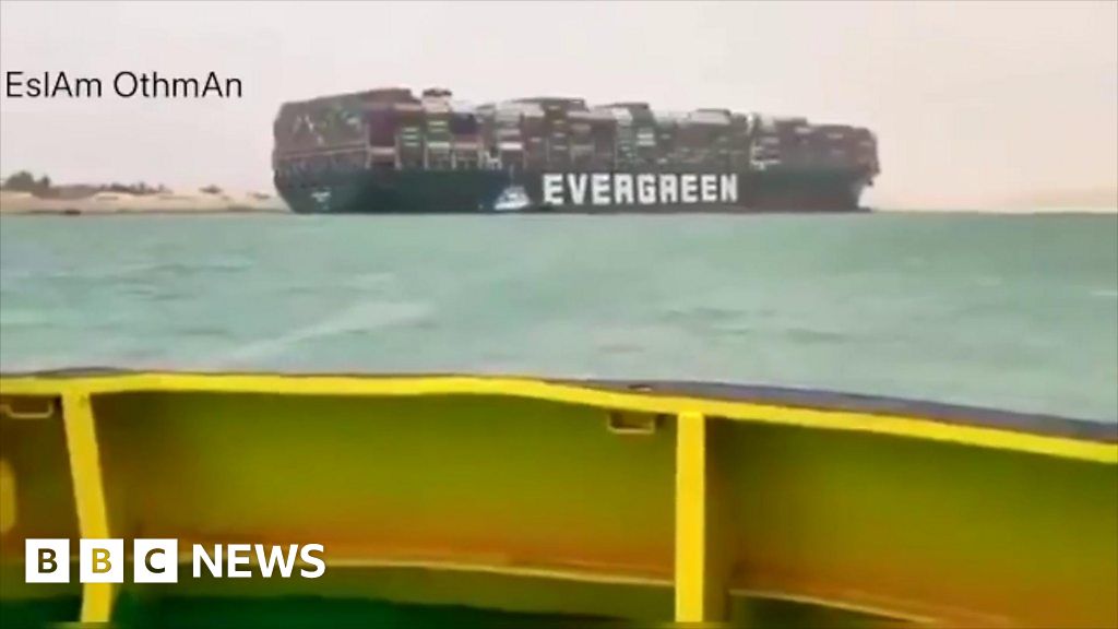 Suez Canal: Wedged container ship seen in busy waterway
