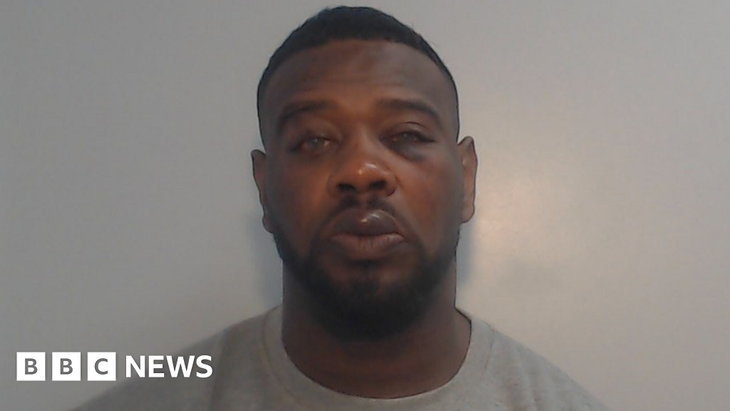 Manchester man who attacked police with hammer and axe jailed - BBC News