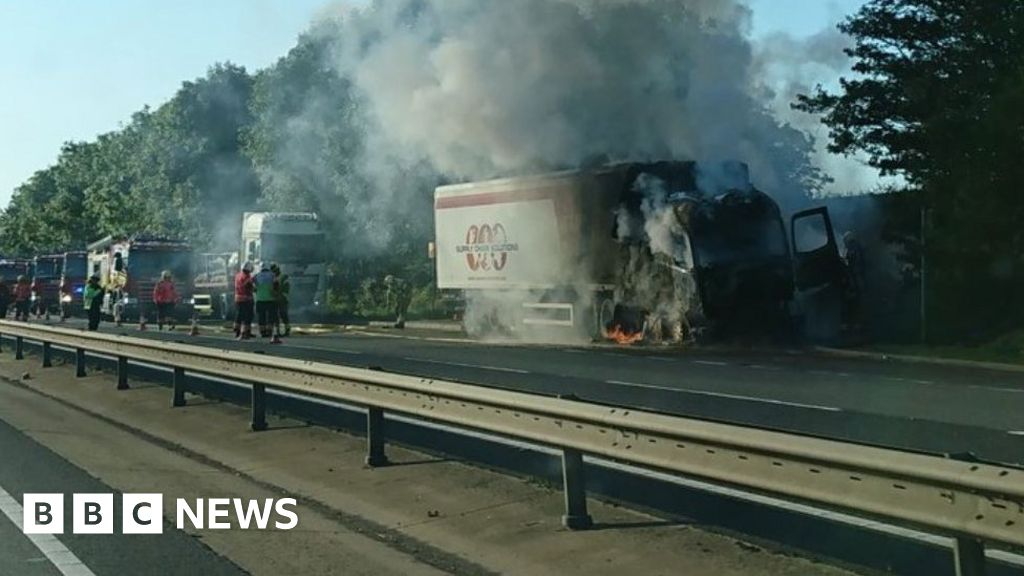 A14 lorry driver wakes to find cab in fire in Cambridgeshire - BBC News