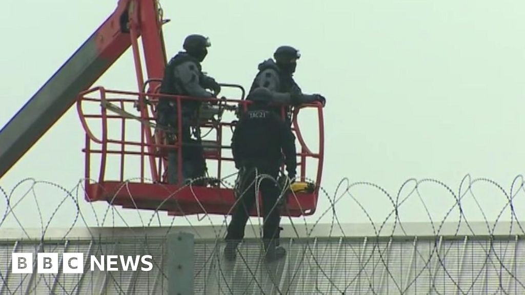 Berwyn prison: Riot gear officers take prisoner off roof