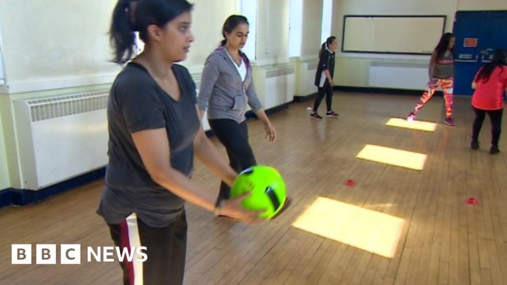 The mums playing football at their children's school